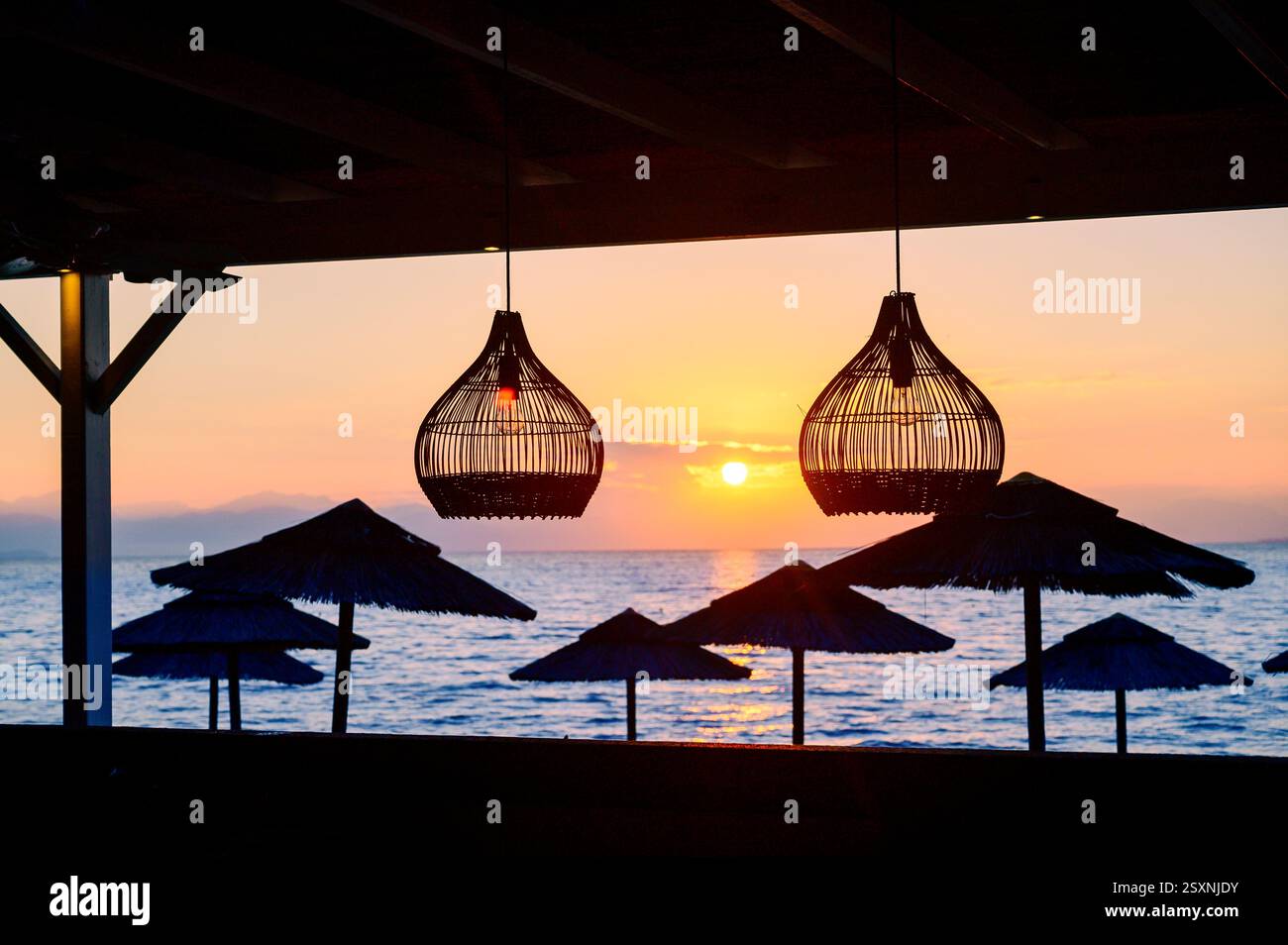 Beach restaurant at sunset Stock Photo - Alamy