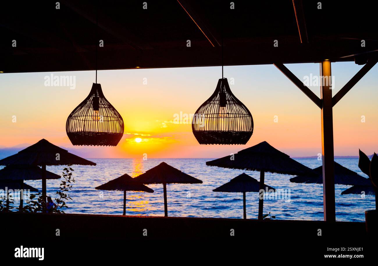 Beach restaurant at sunset Stock Photo - Alamy