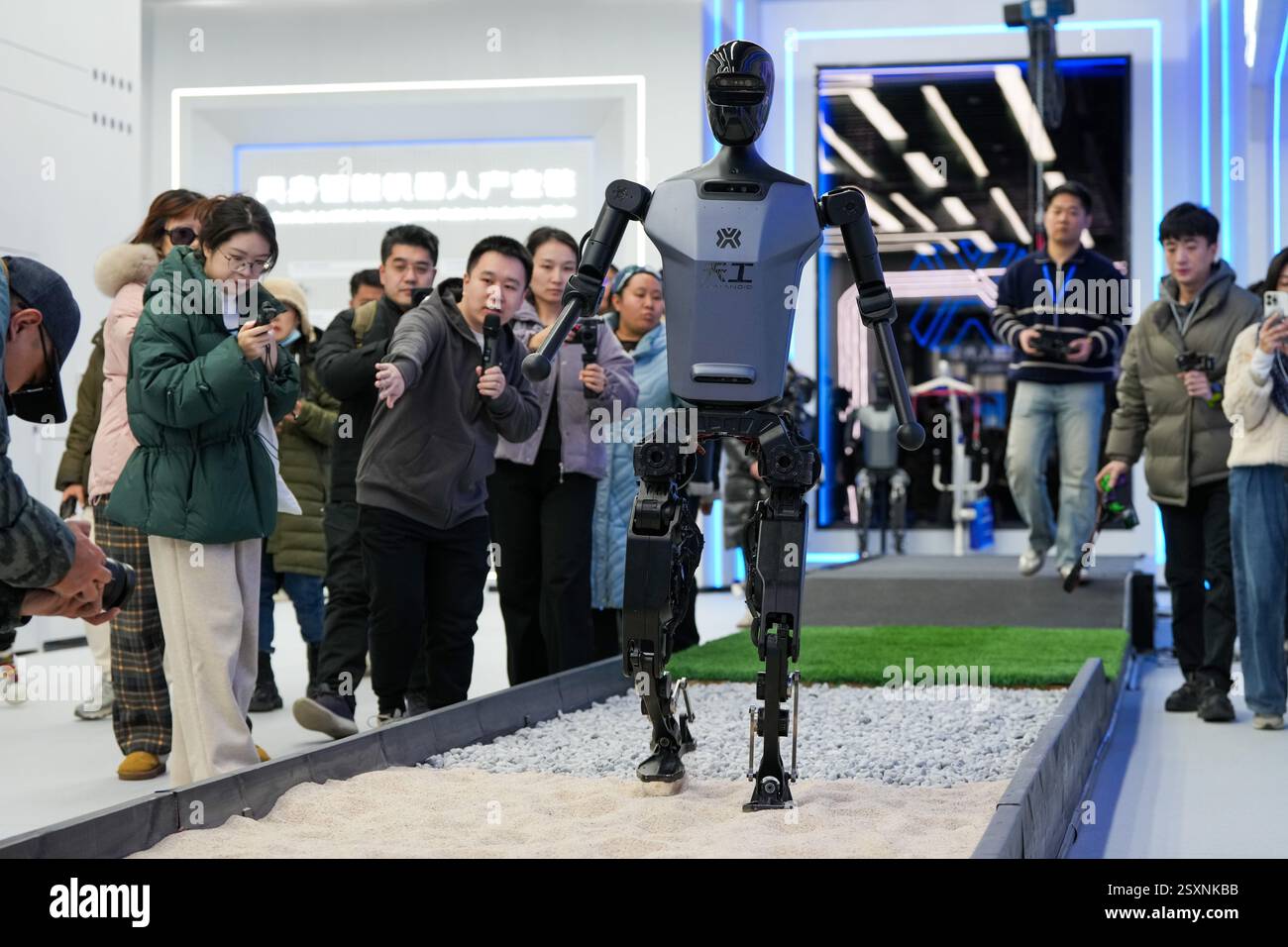 Beijing, China. 24th Feb, 2025. People visit a "Tiangong" humanoid robot at the Beijng World of ...