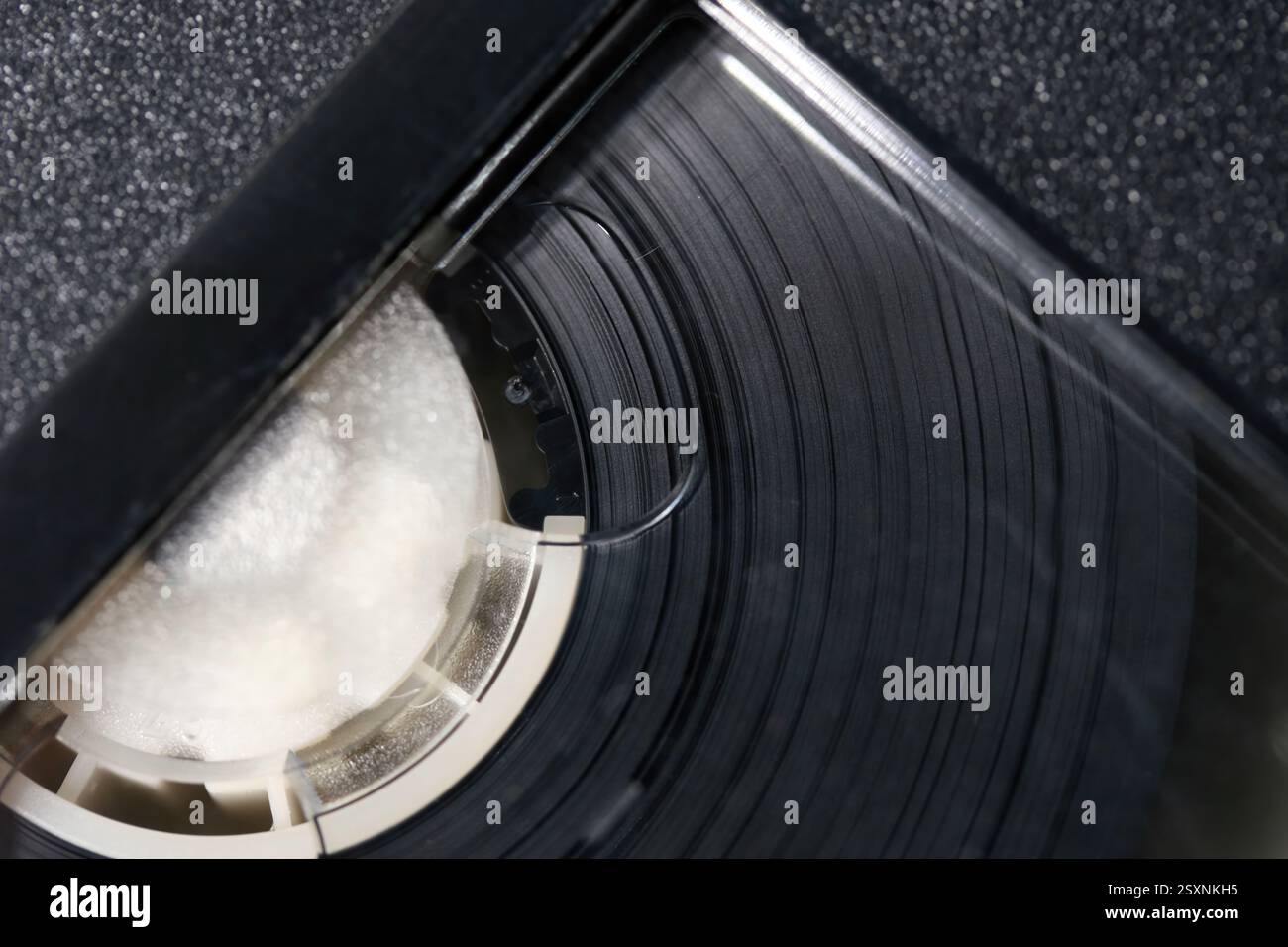 Close up view of a VHS cassette tape revealing the magnetic tape and ...