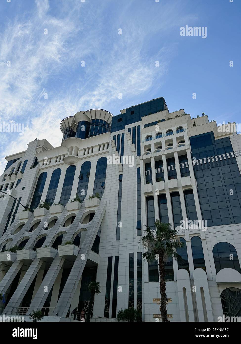 The image captures a high-rise building with a distinctive ...