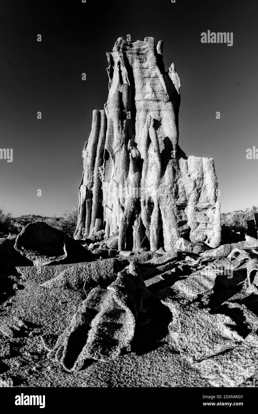 Large rock formation with a small hole in the middle. The rock is grey ...