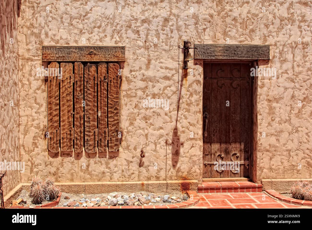 Building with a door and two windows. The door is wooden and has a ...