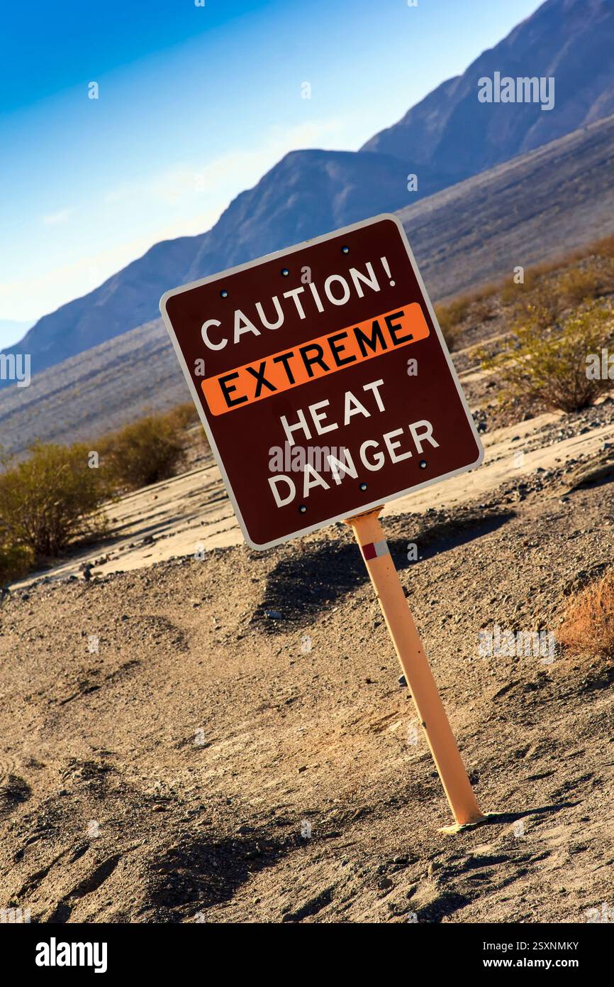 Sign warning of extreme heat danger. The sign is brown and orange. It ...