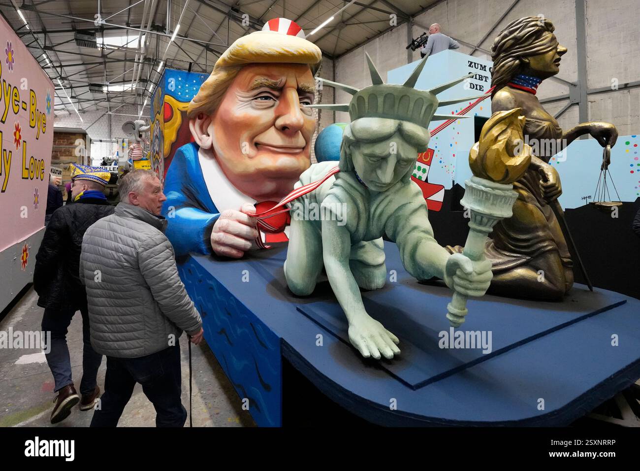 A carnival float depicts the Statue of Liberty and Lady Justice on ...