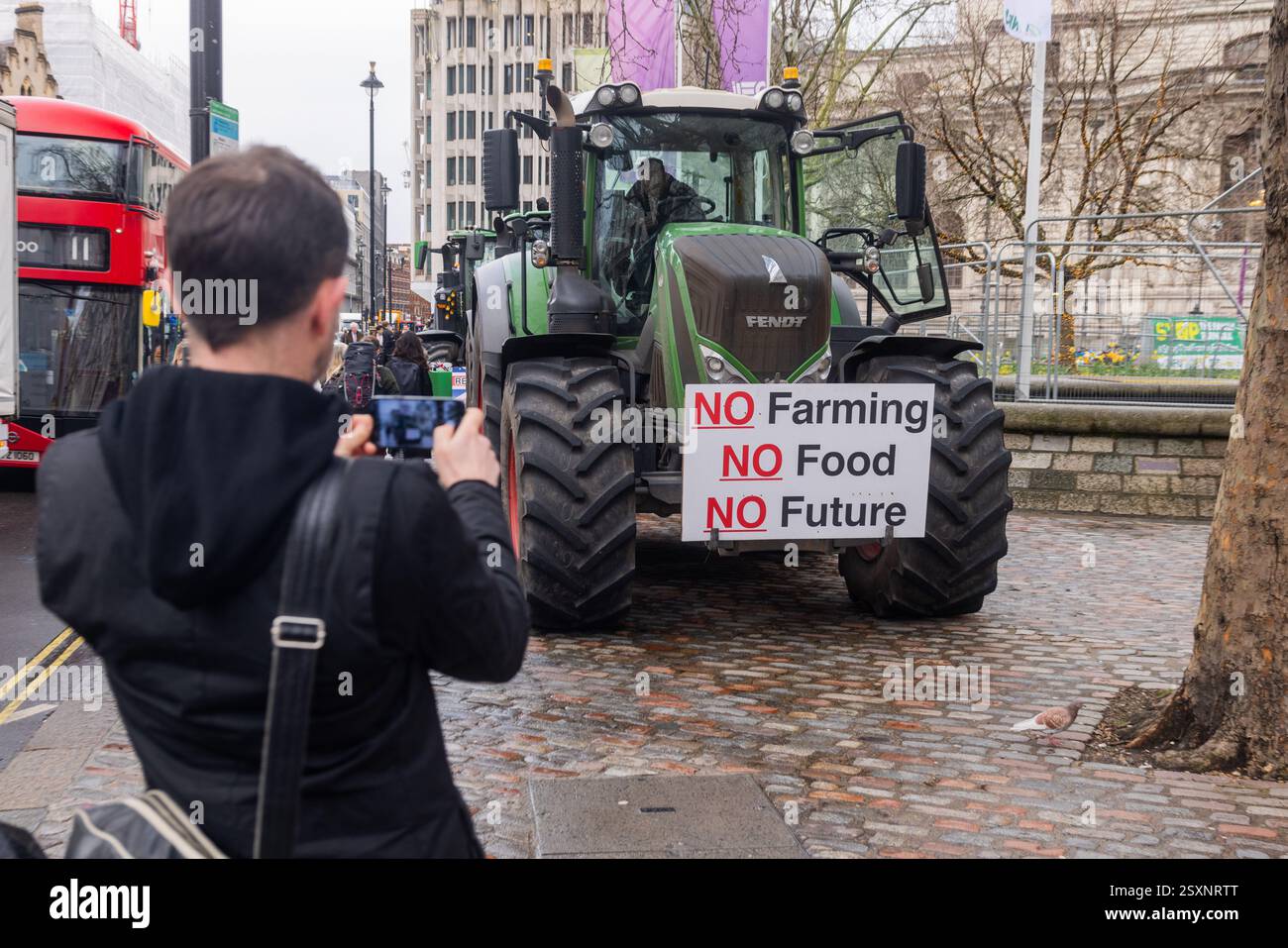 London, UK. 25 FEB, 2025. Man takes photo at the tractor protest ...