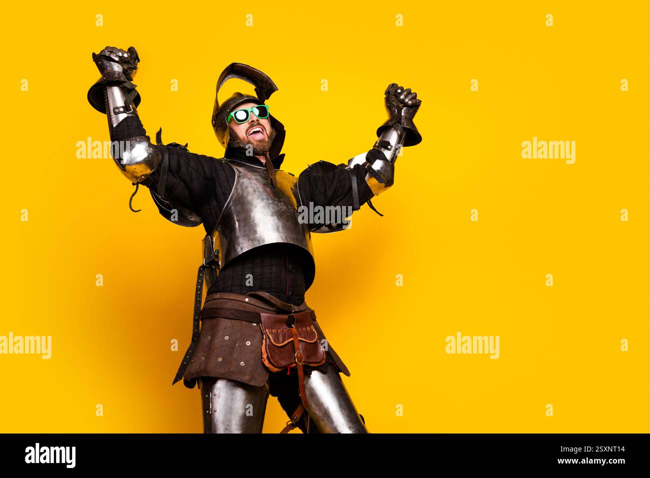 Man in Medieval Armor Poses Playfully in Bright Yellow Background Stock ...