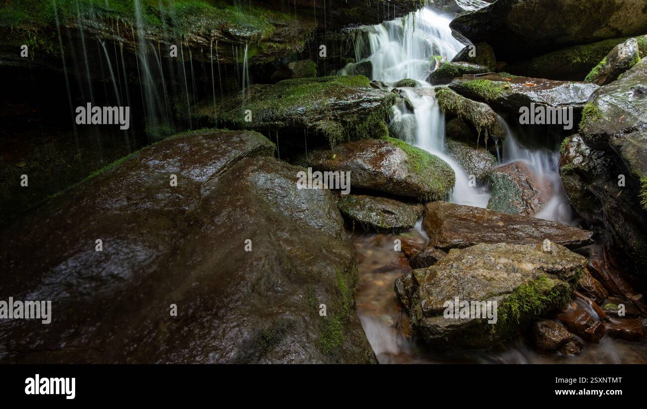 Silky water forms hidden waterfall serenity. Otter Falls waterfall in ...