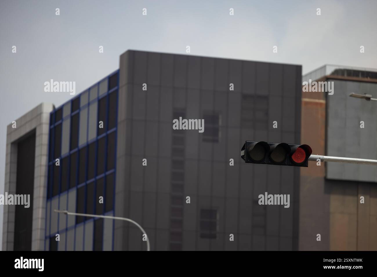 The red traffic light flickered, signaling to prepare for the imminent ...