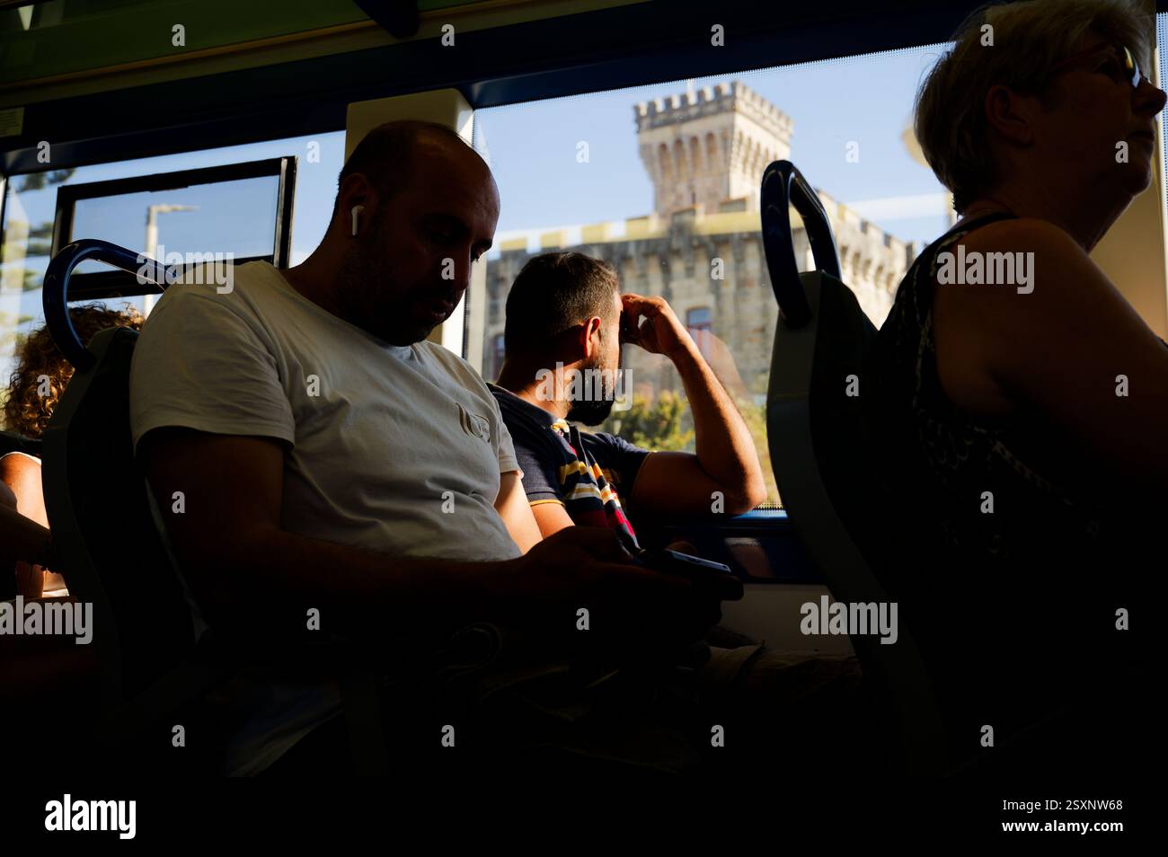 Passengers on a train from Cascais to Lisbon, absorbed in thought and ...