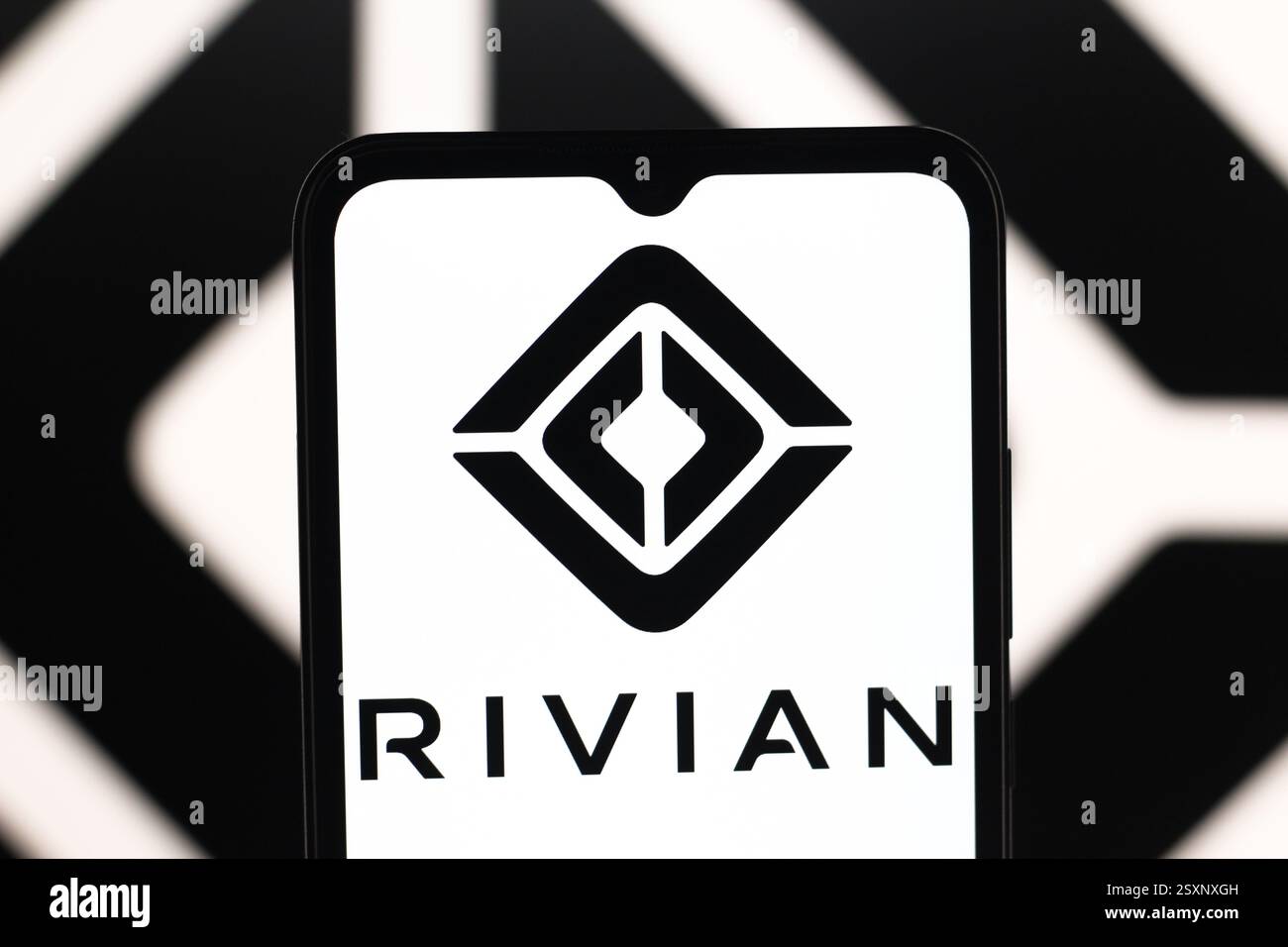 In this photo illustration, the Rivian Automotive logo is seen ...