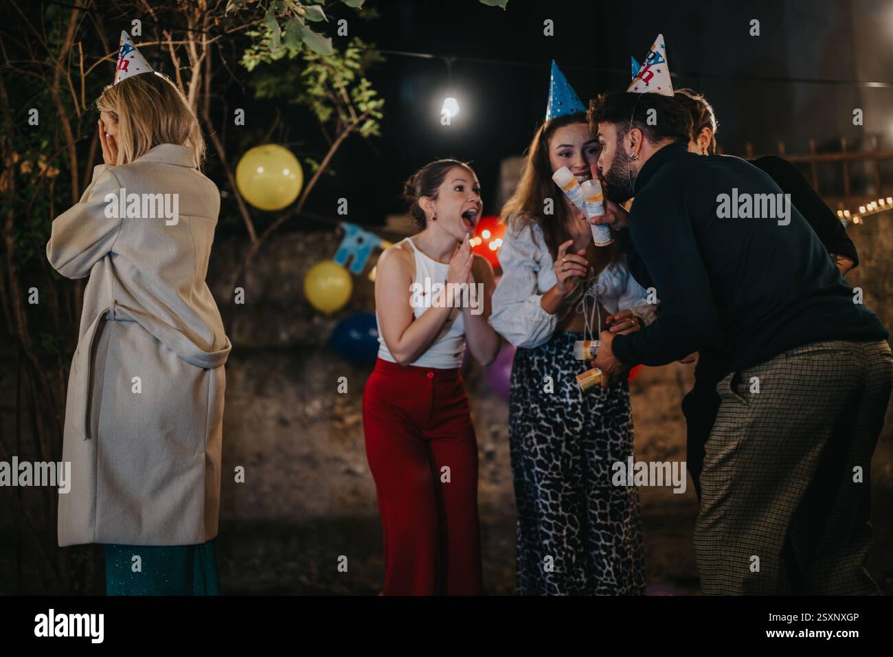 Group of young adults celebrating party at evening showcasing joy and ...