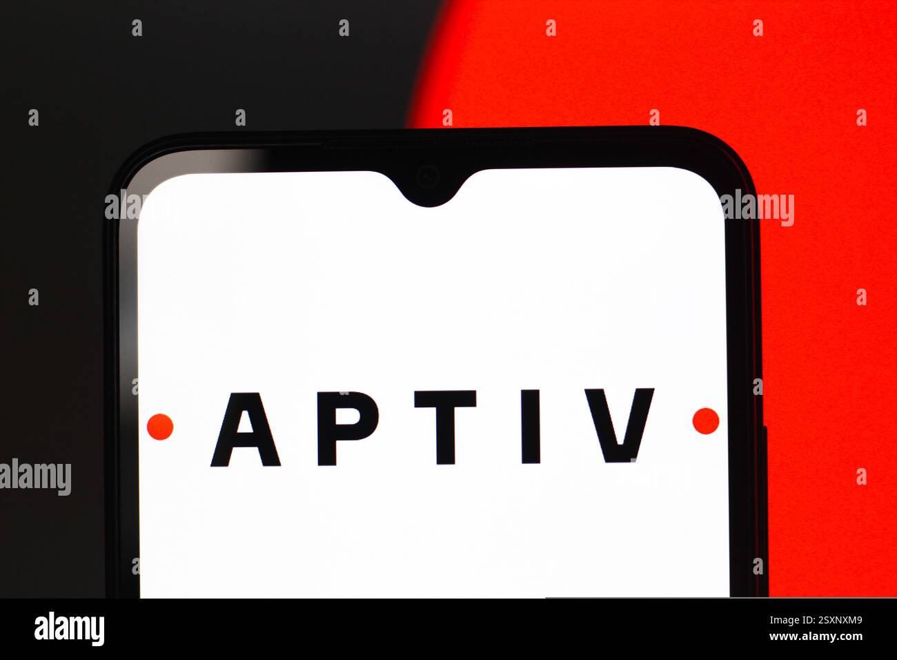 In this photo illustration, the Aptiv logo is seen displayed on a ...