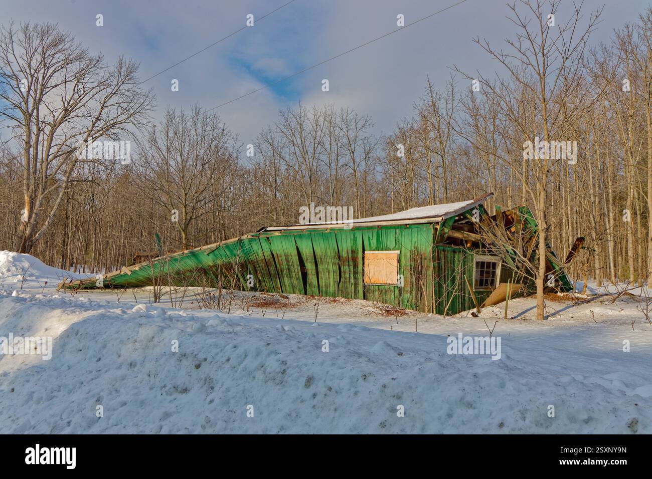 Old green barn collapses due to age and heavy snow load in winter Stock ...
