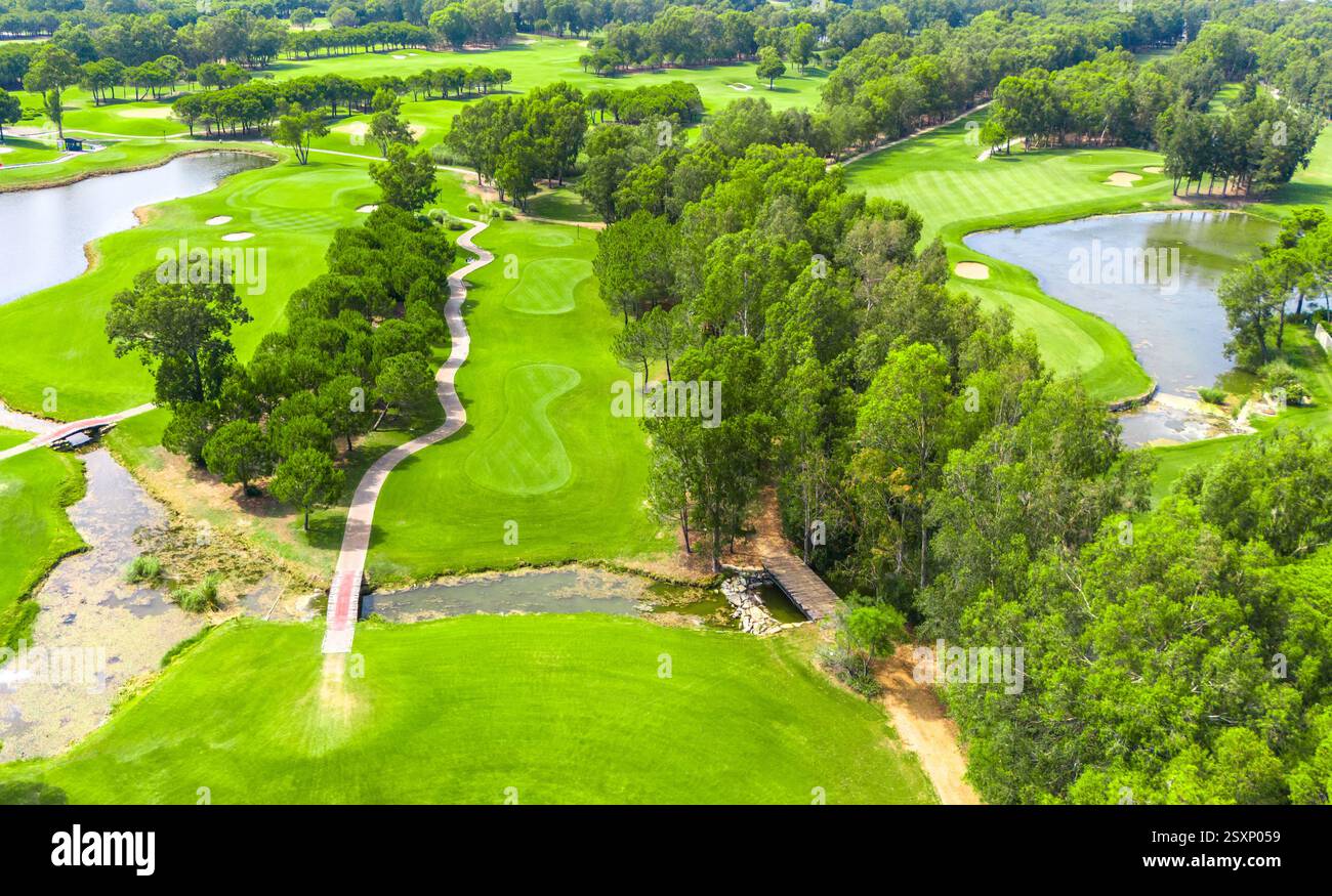 Aerial view of a golf course with trees, ponds, and winding paths Stock ...