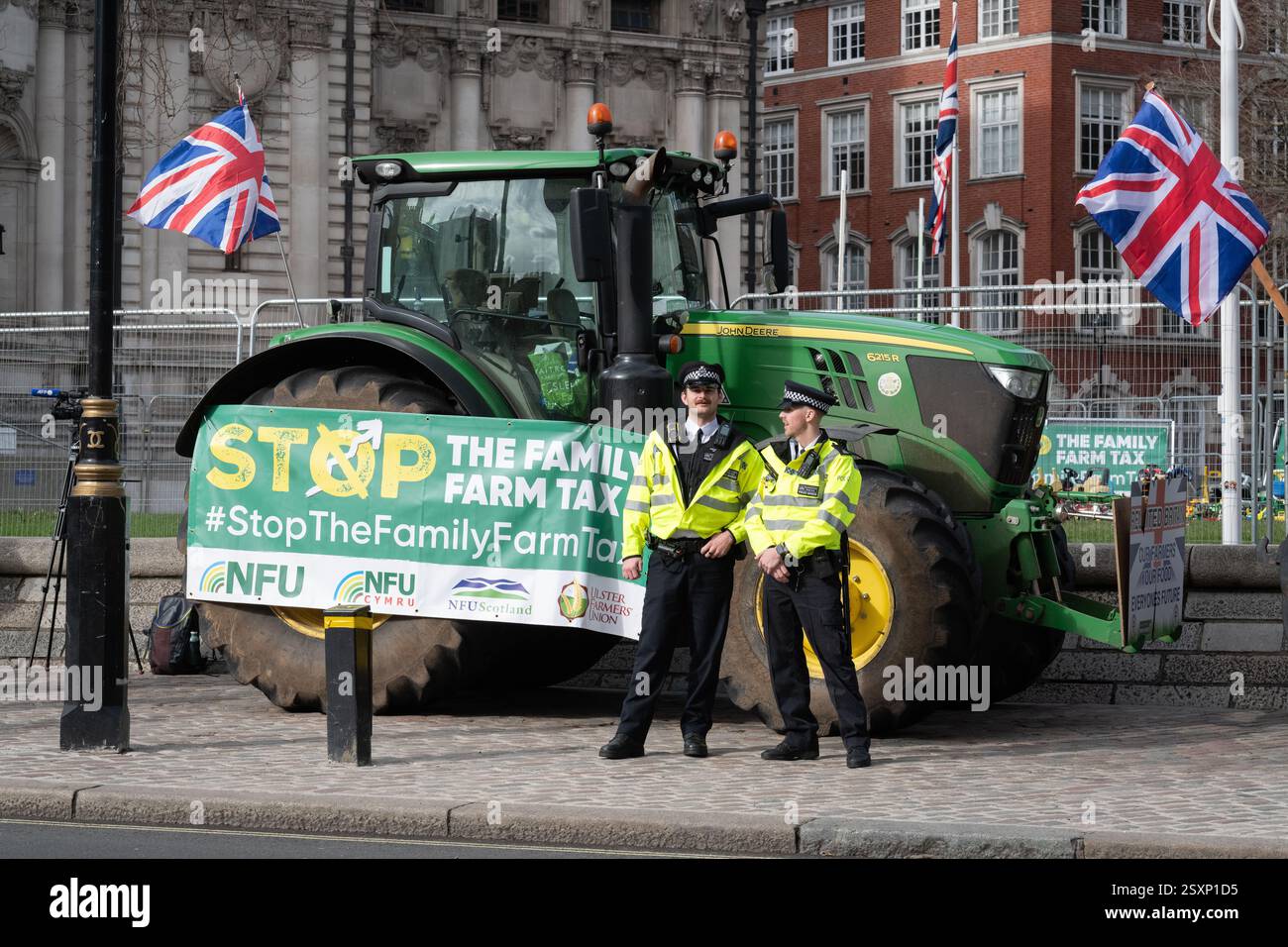 London, UK. 25 February, 2025. Two police officers stand by a parked ...