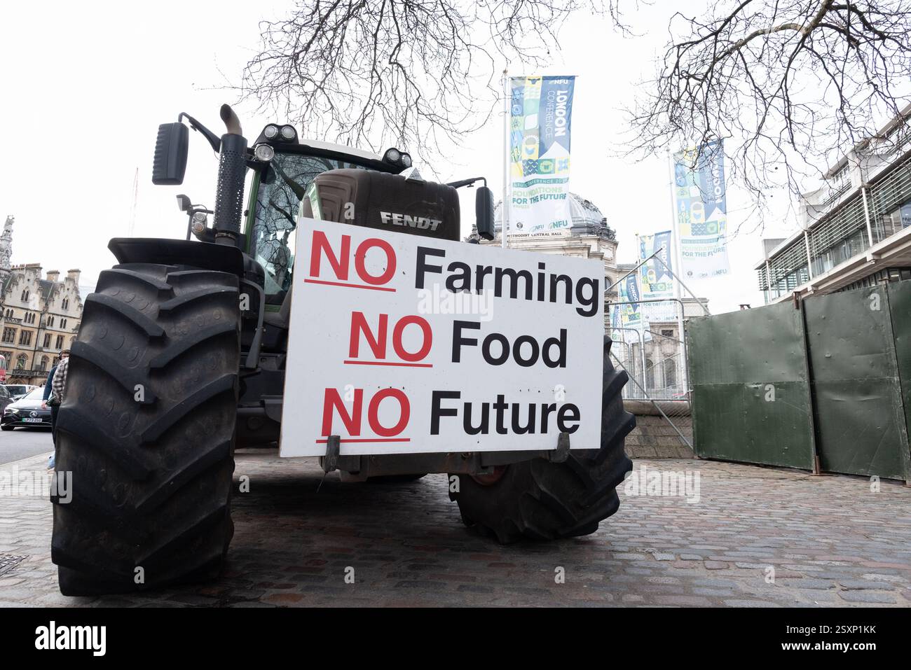 London, UK. 25 February, 2025. A tractor bearing a placard saying "No ...