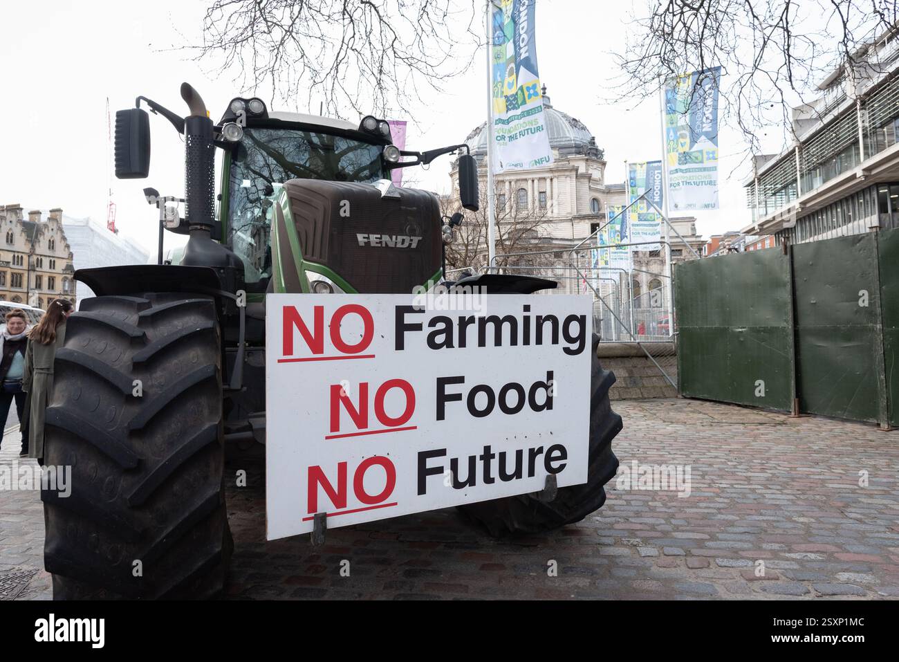 London, UK. 25 February, 2025. A tractor bearing a placard saying "No ...
