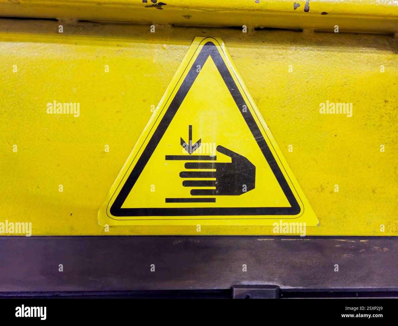 Yellow Safety Warning Sign Indicating Hand Hazard on Industrial ...