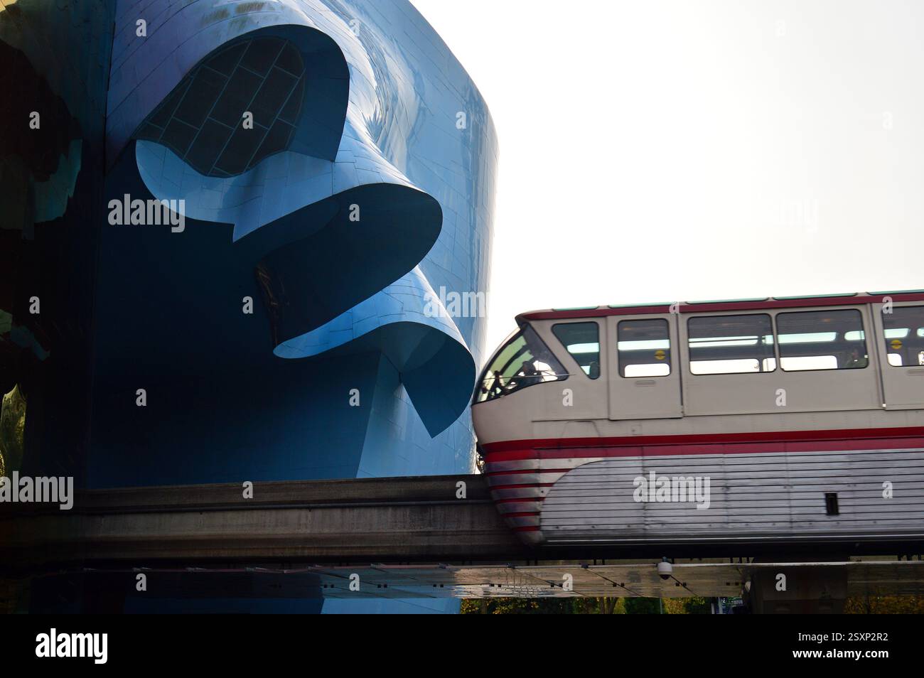 A monorail enters the Music Experience building in Seattle Stock Photo ...