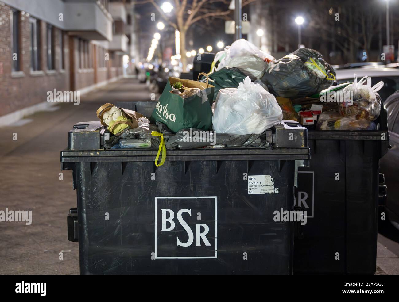Berlin, Germany. 23rd Feb, 2025. Overflowing garbage containers with ...