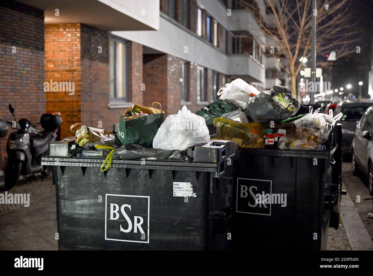 Berlin, Germany. 23rd Feb, 2025. Overflowing garbage containers with ...