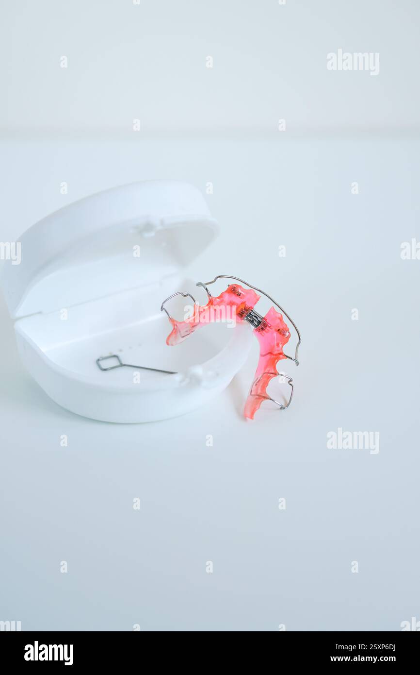 An orthodontic palatal expander with an adjustment key in a white ...