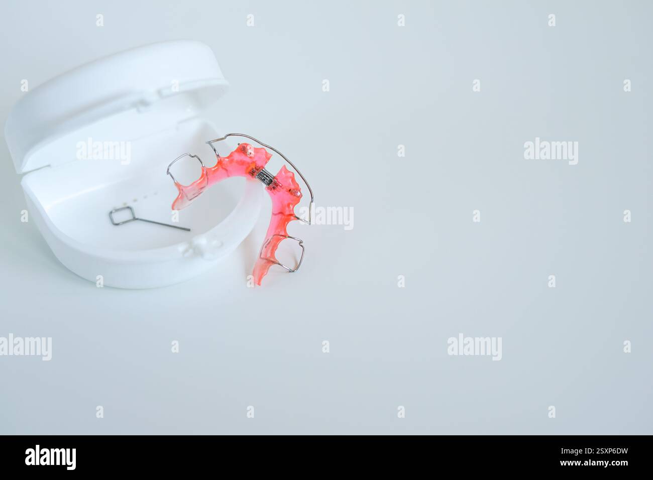 An orthodontic palatal expander with an adjustment key in a white ...