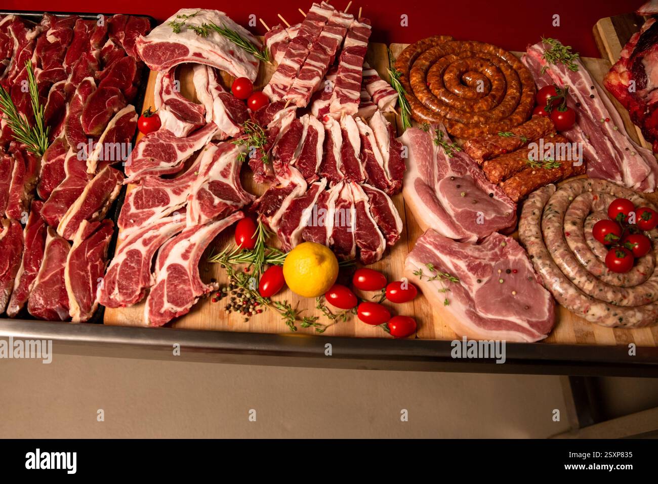 Sausages and raw meat lamb on the table in meat industry. Butchered ...