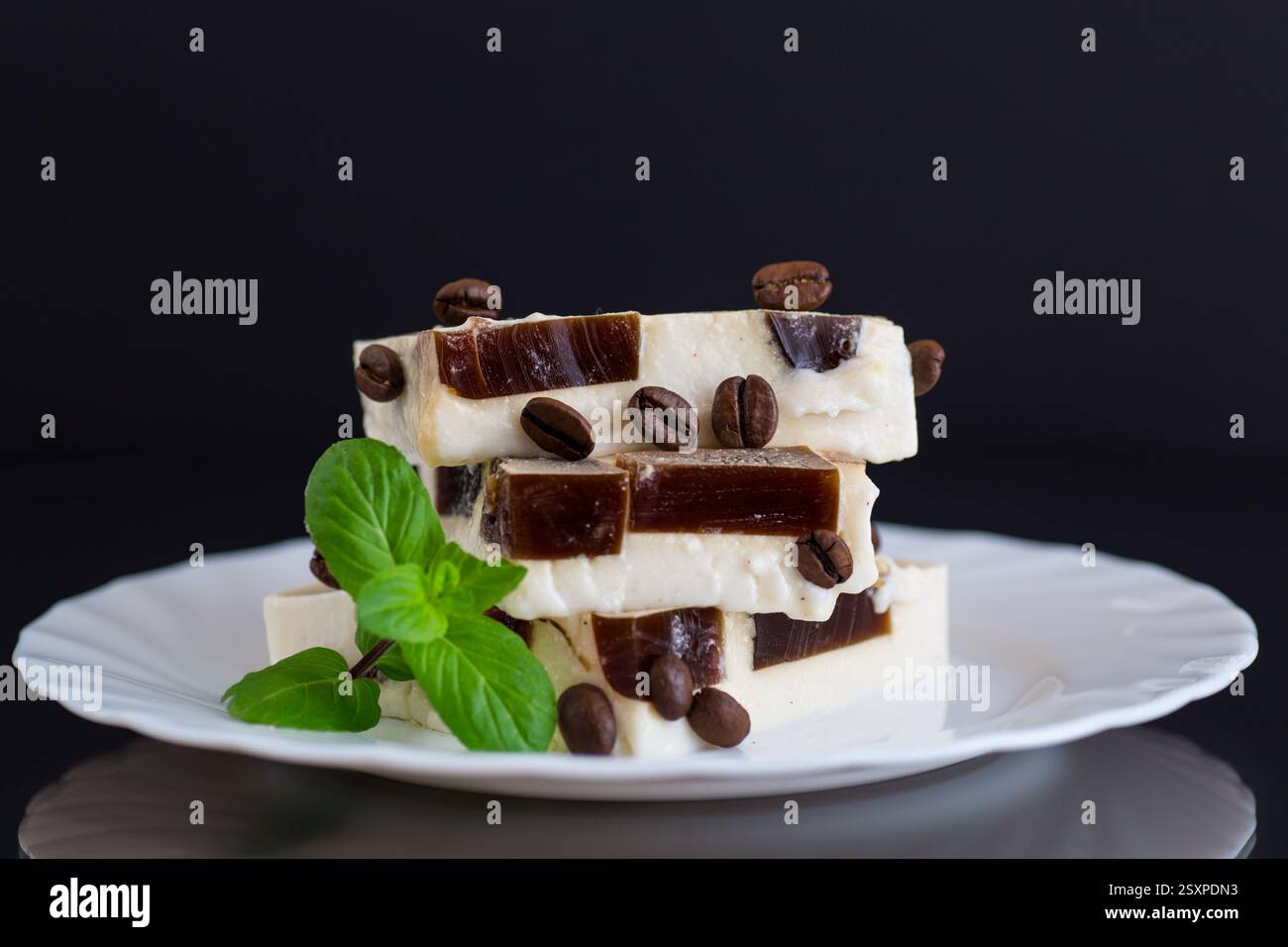 coffee jelly pieces inside white milk jelly Stock Photo - Alamy