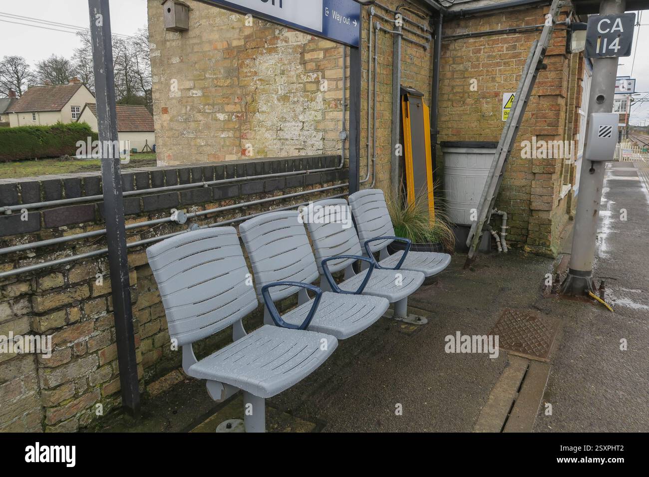 Wet seats on the platform of Foxton Railway Station Stock Photo - Alamy