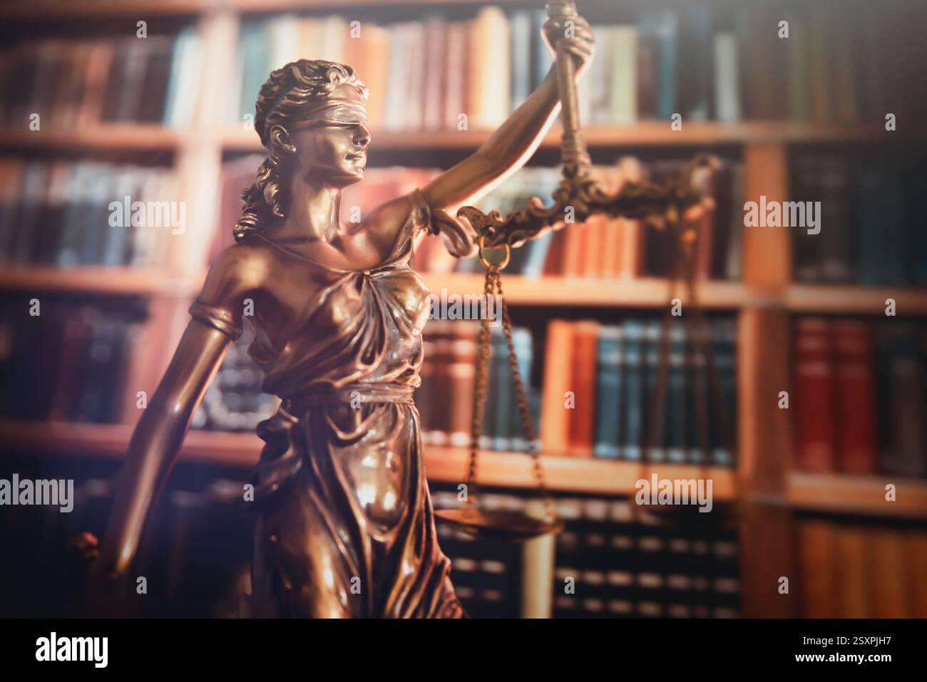 The Statue of Justice symbol in library with lot of books. Legal law ...