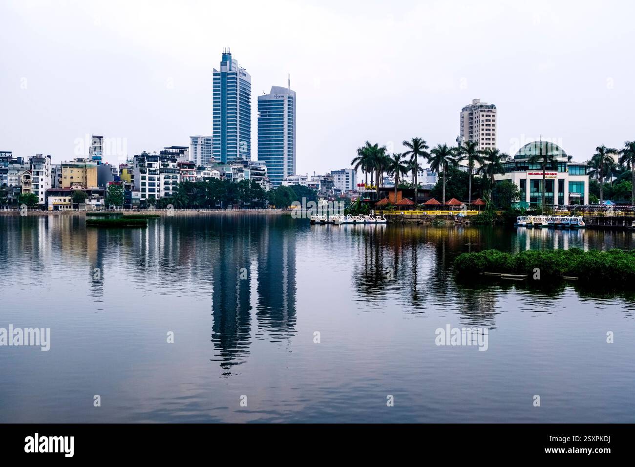 The skyline of Hanoi s city centre is reflected on the surface of the ...