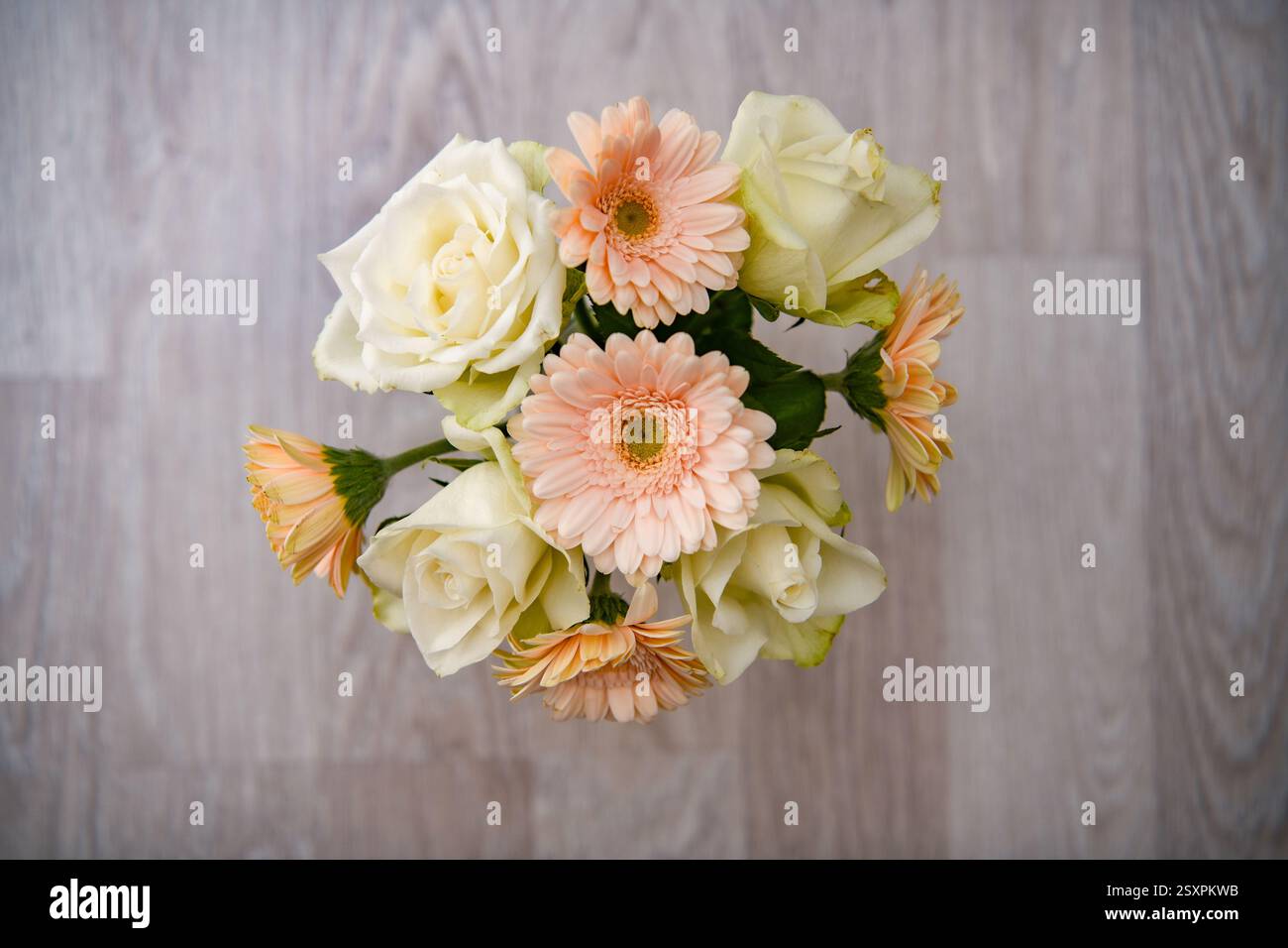 bouquet of colorfull Gerbera flowers and white roses on a wooden ...