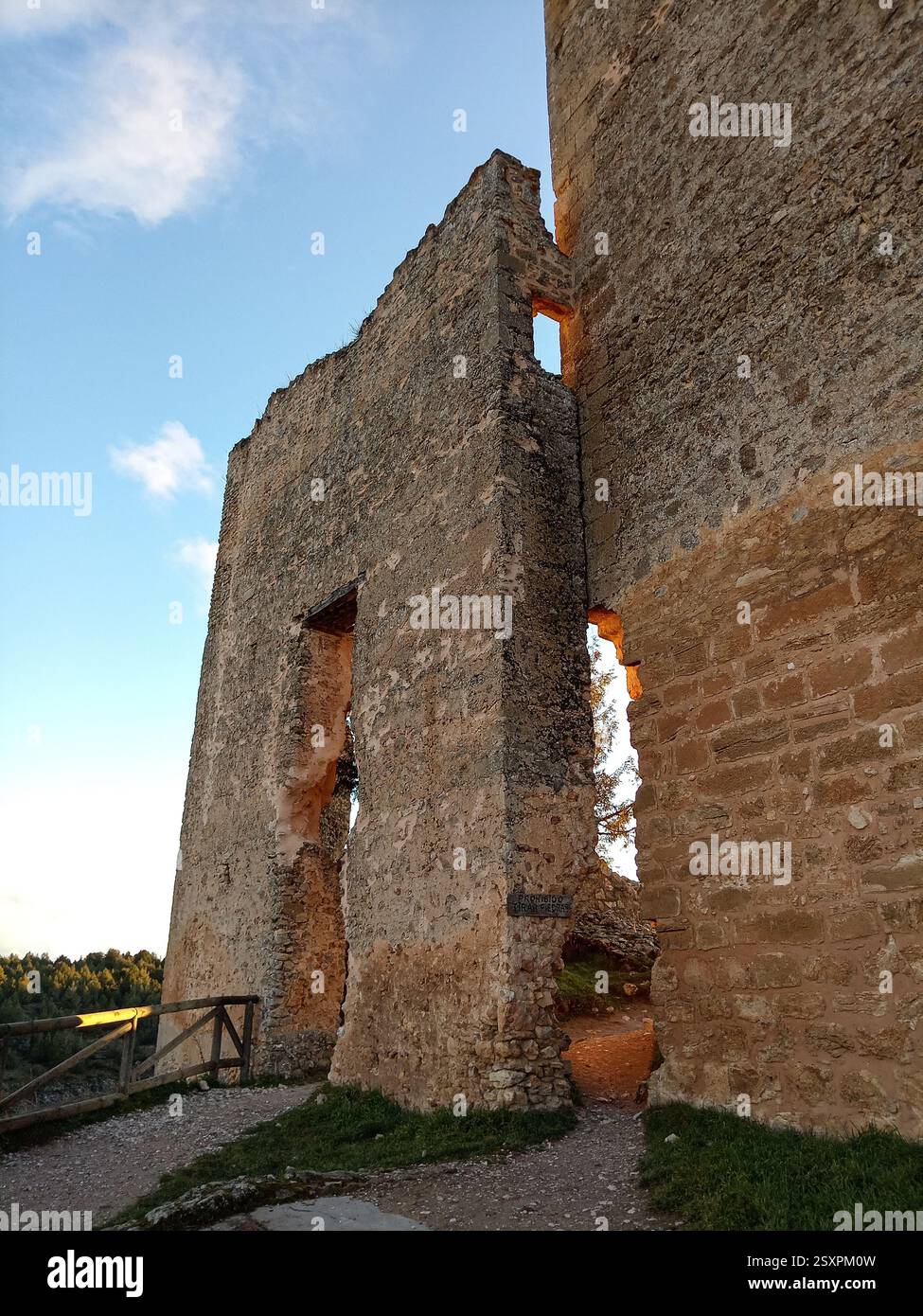 Weathered stone walls of the Castle of Calataazor, illuminated by warm ...