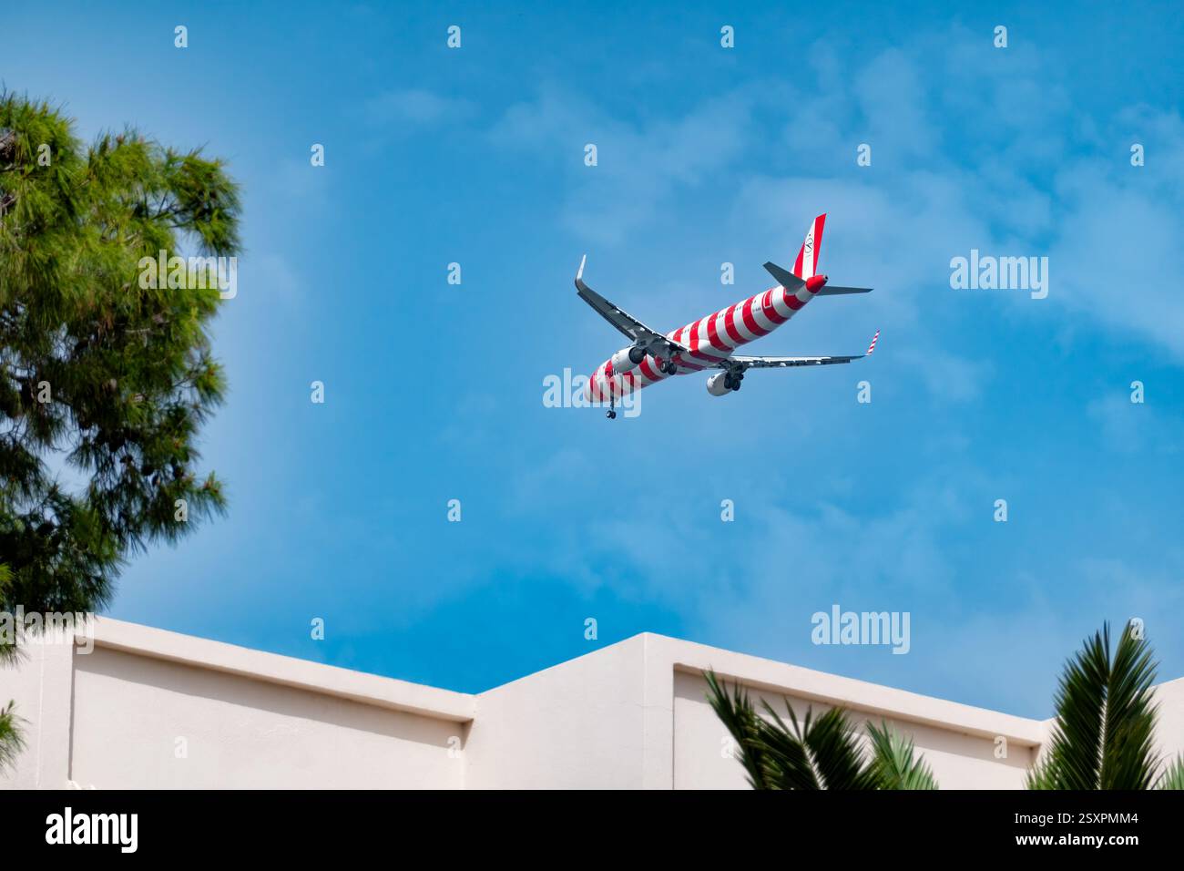 Rhodes Greece. A red striped Condor Airlines plane on its approach to ...