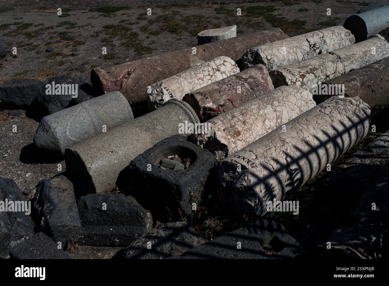 Granite, marble and black basalt: broken columns and shaped lava stone ...