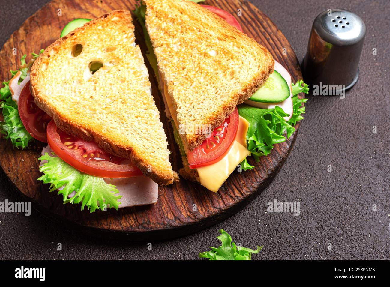 Club sandwich cut in half close up. Ham and cheddar cheese sandwich ...