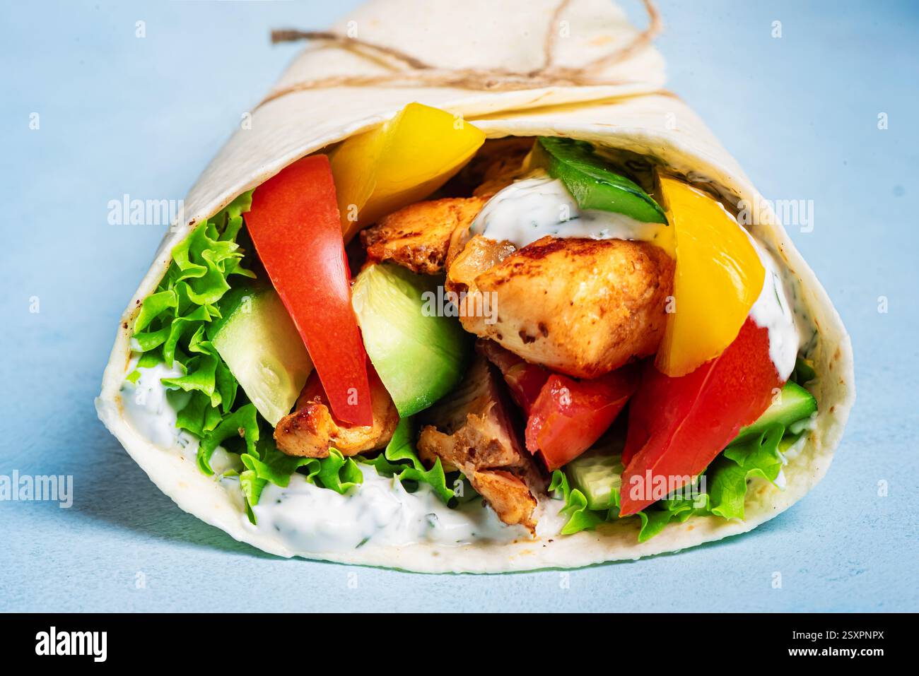 Traditional Turkish doner kebab in tortilla wrap with fresh vegetables ...