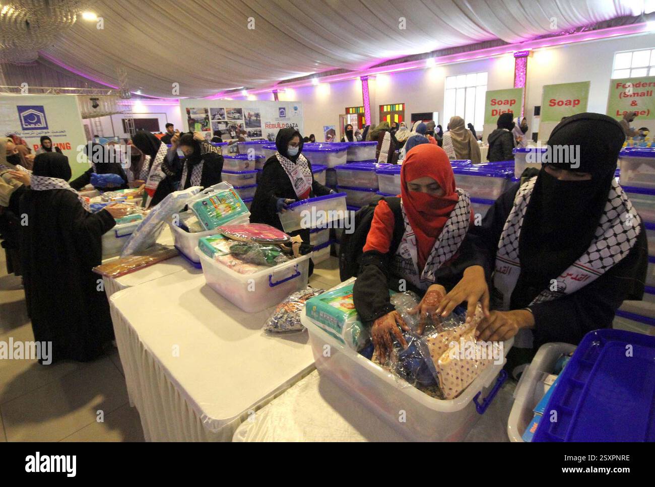 Volunteers are busy in packing of relief box during Gaza Packing Drive ...
