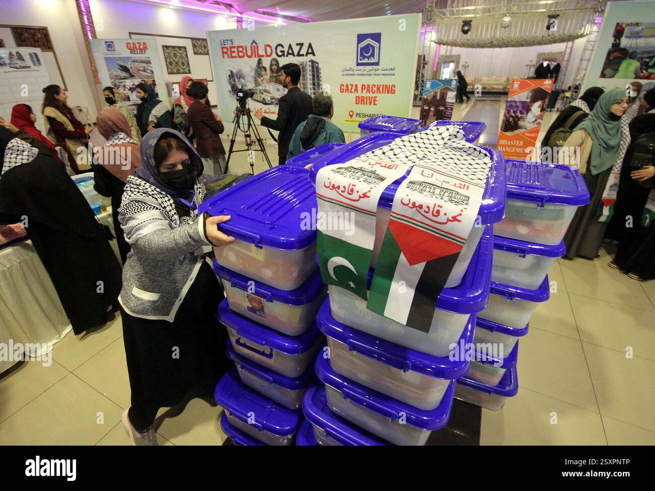 Volunteers are busy in packing of relief box during Gaza Packing Drive ...