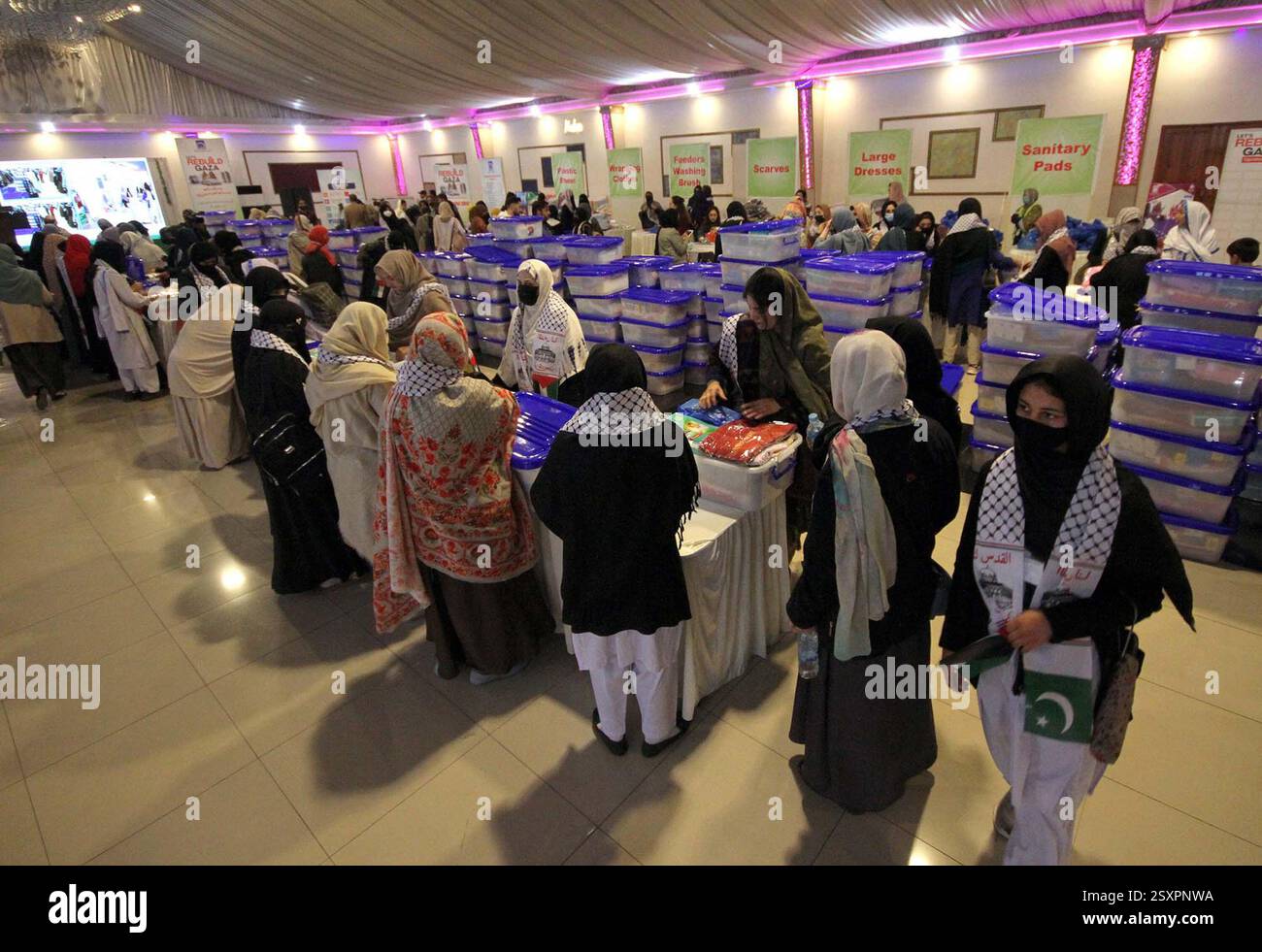 Volunteers are busy in packing of relief box during Gaza Packing Drive ...