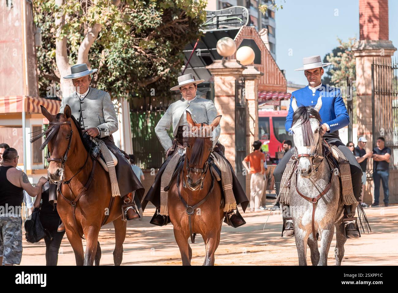 Group of Spanish riders in traditional attire on horseback at an ...