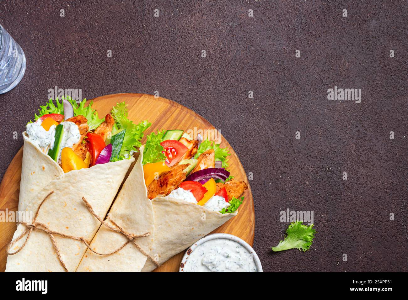 Greek chicken souvlaki or gyros wraps with vegetables and tzatziki ...