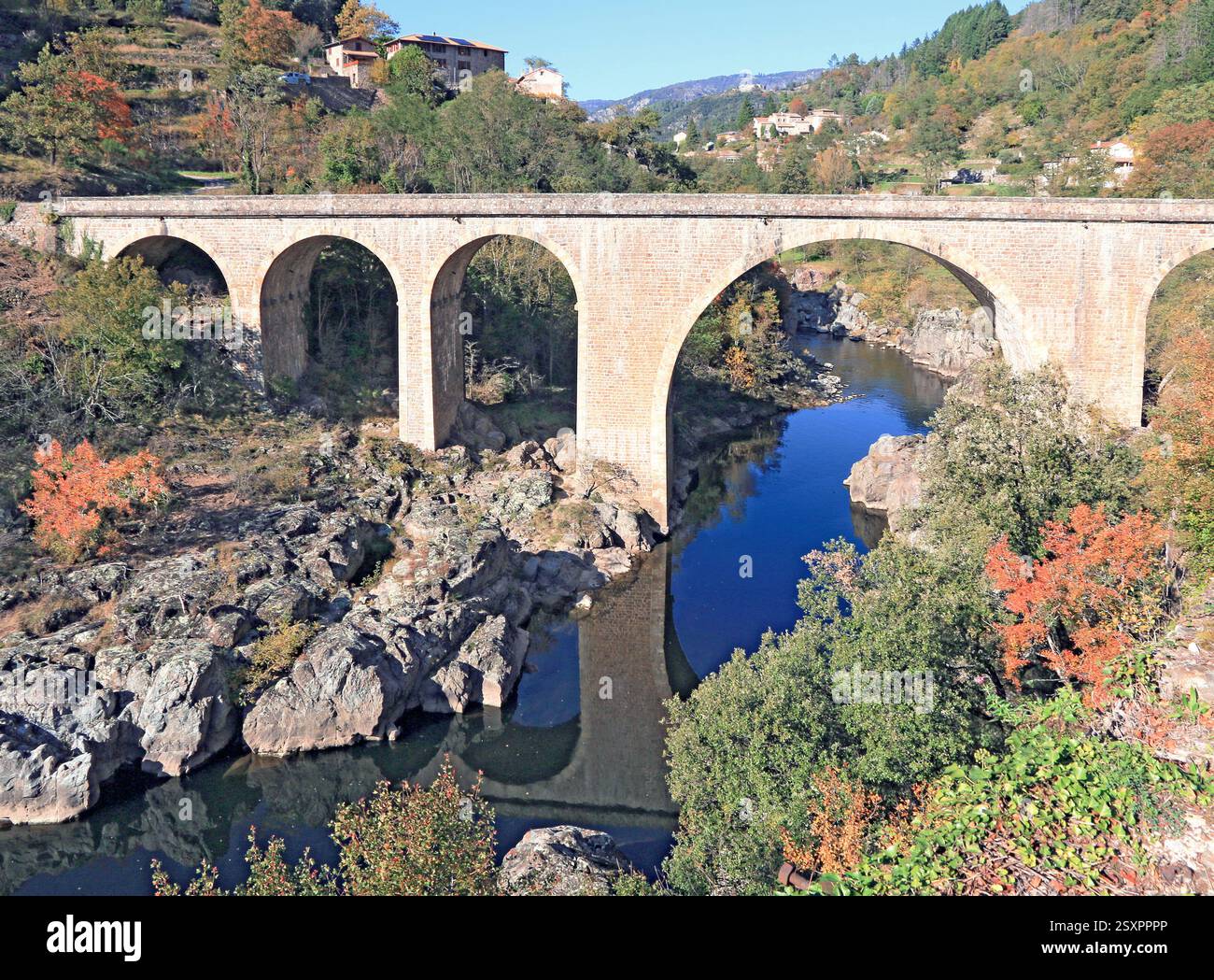 Rustic bridge spanning the river in the Eyrieux valley in Ardèche ...