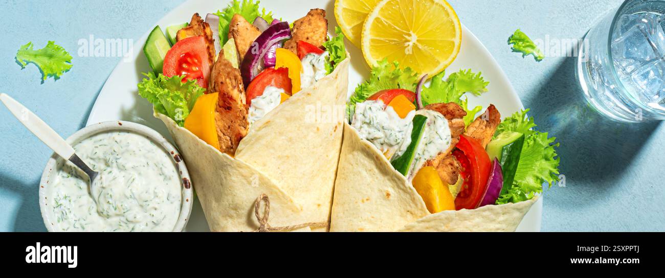 Greek chicken souvlaki or gyro wraps with vegetables and tzatziki sauce ...
