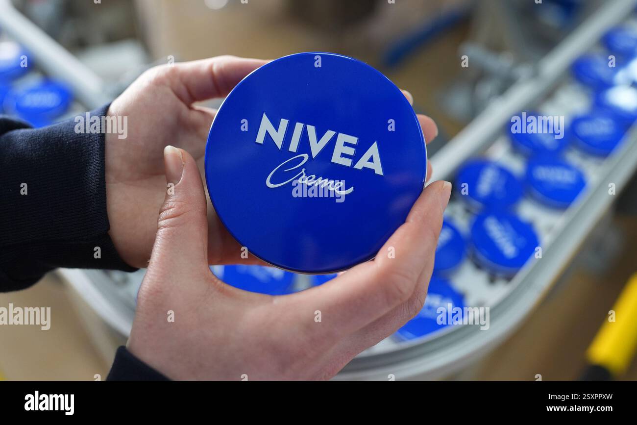 Hamburg, Germany. 25th Feb, 2025. An employee holds a can of Nivea ...