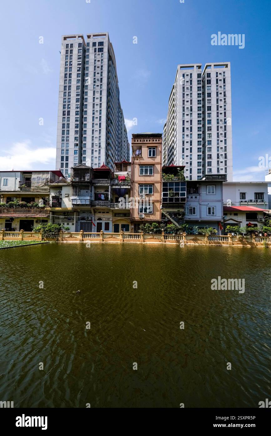 Small traditional buildings and two tower blocks behind them, seen ...