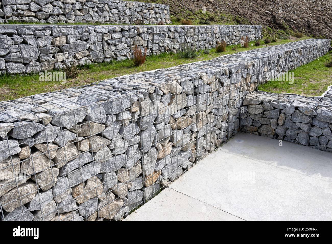 Modern gabion walls made of granite stones and wire mesh, used for ...