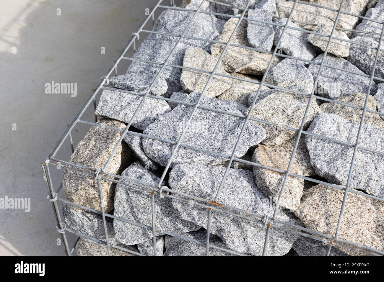 Detail of a gabion wall made of granite stones and wire mesh used for landscaping Stock Photo ...
